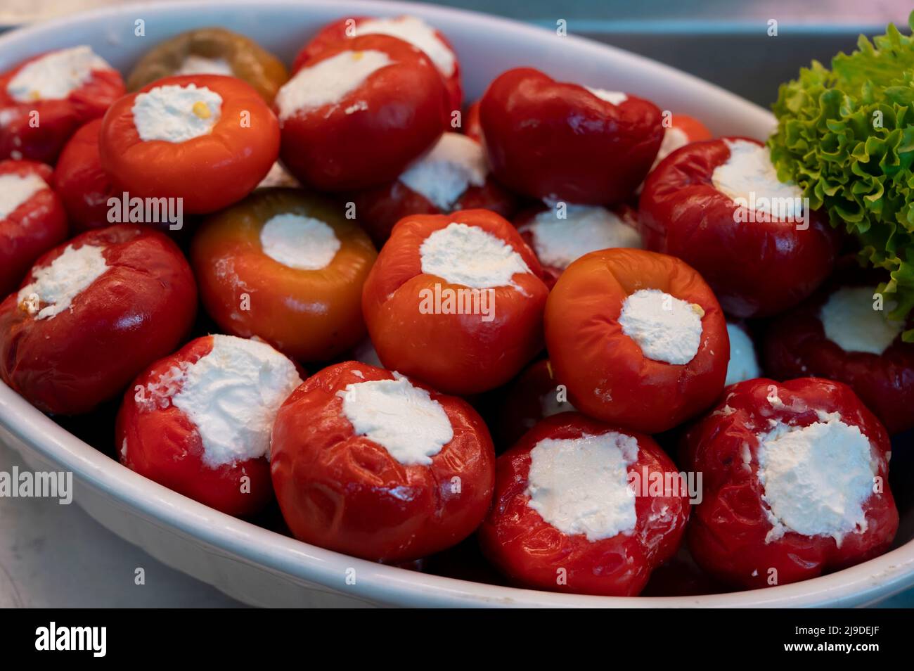 Mediterranean food, sweet red paprika pepper stuffed with soft white ...