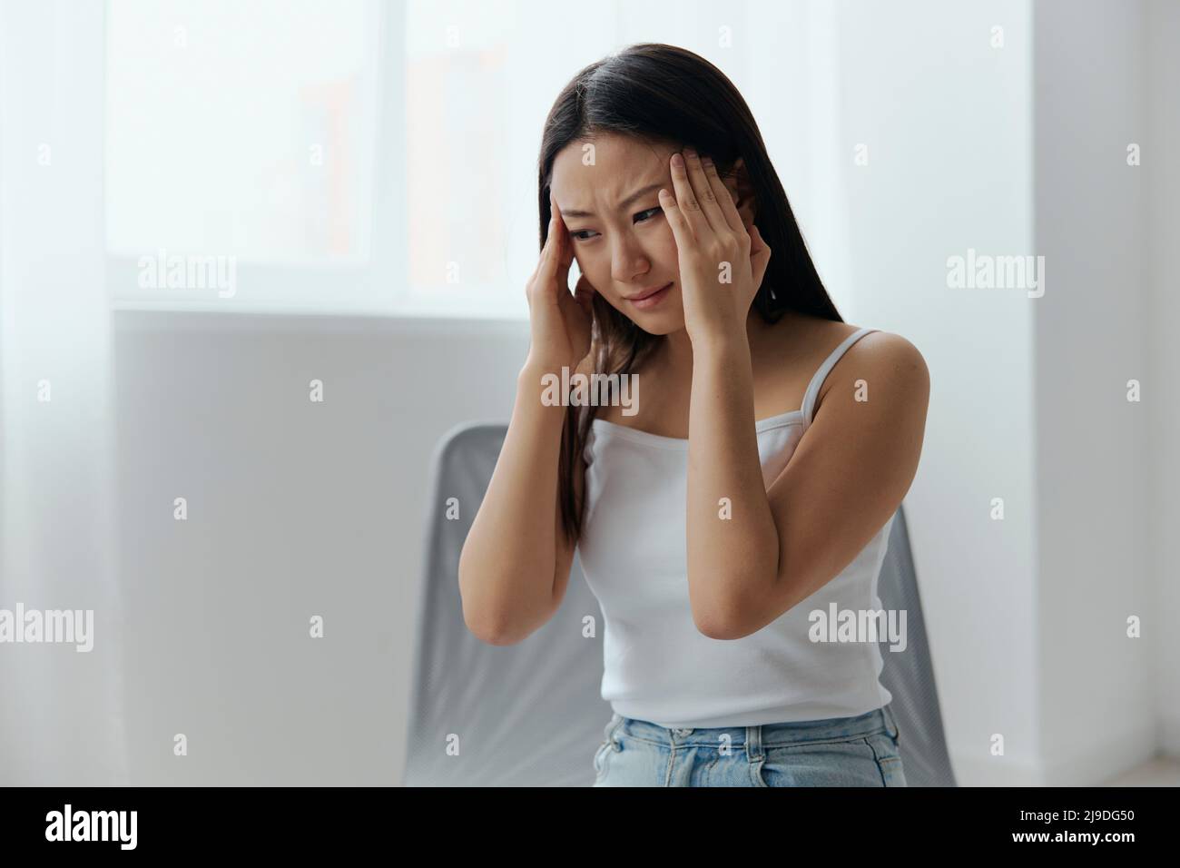 Panic attack. Upset tormented tanned beautiful young Asian woman ...