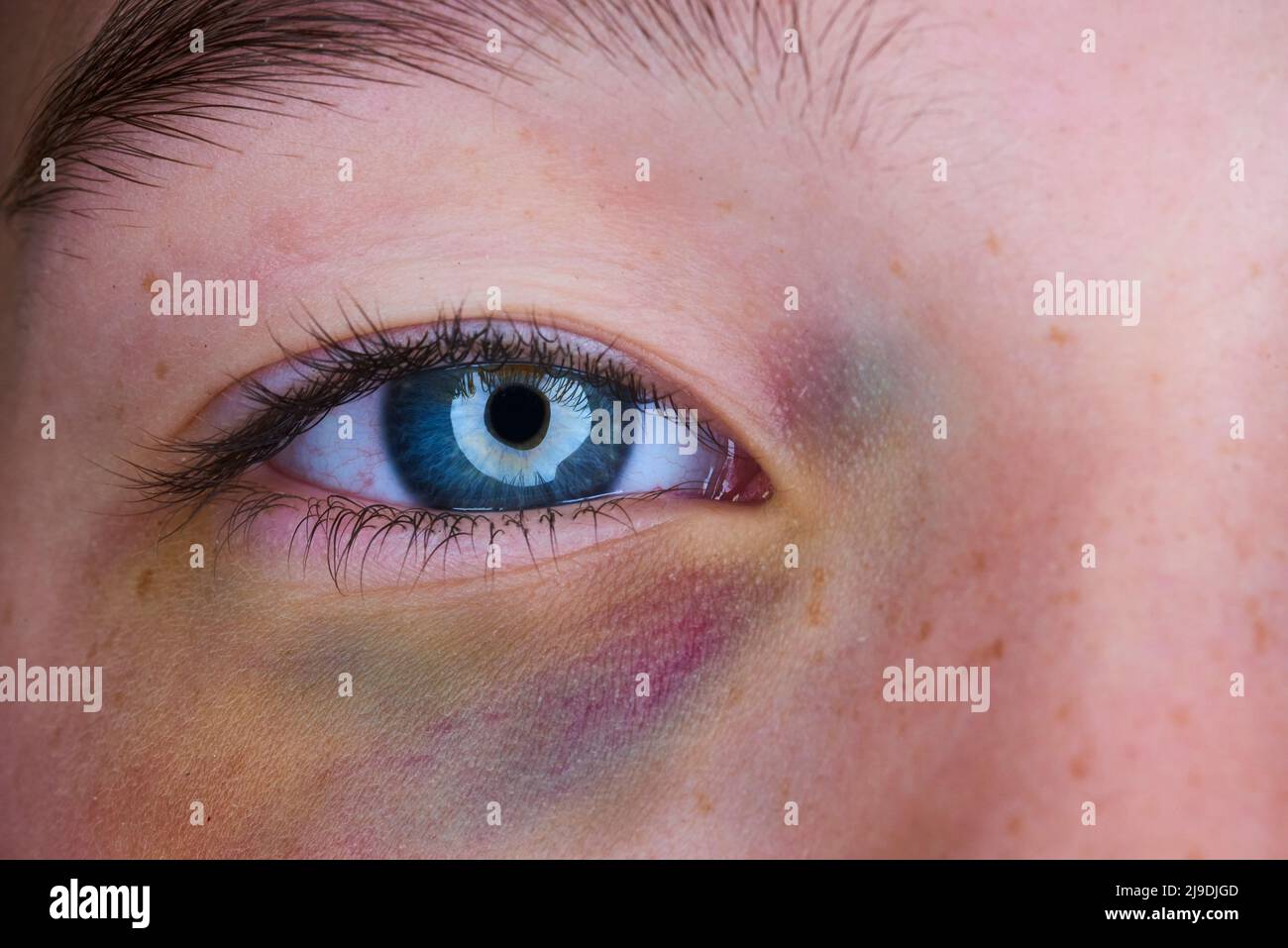 Young smiling woman pilot operating the drone by remote control. Flying ...