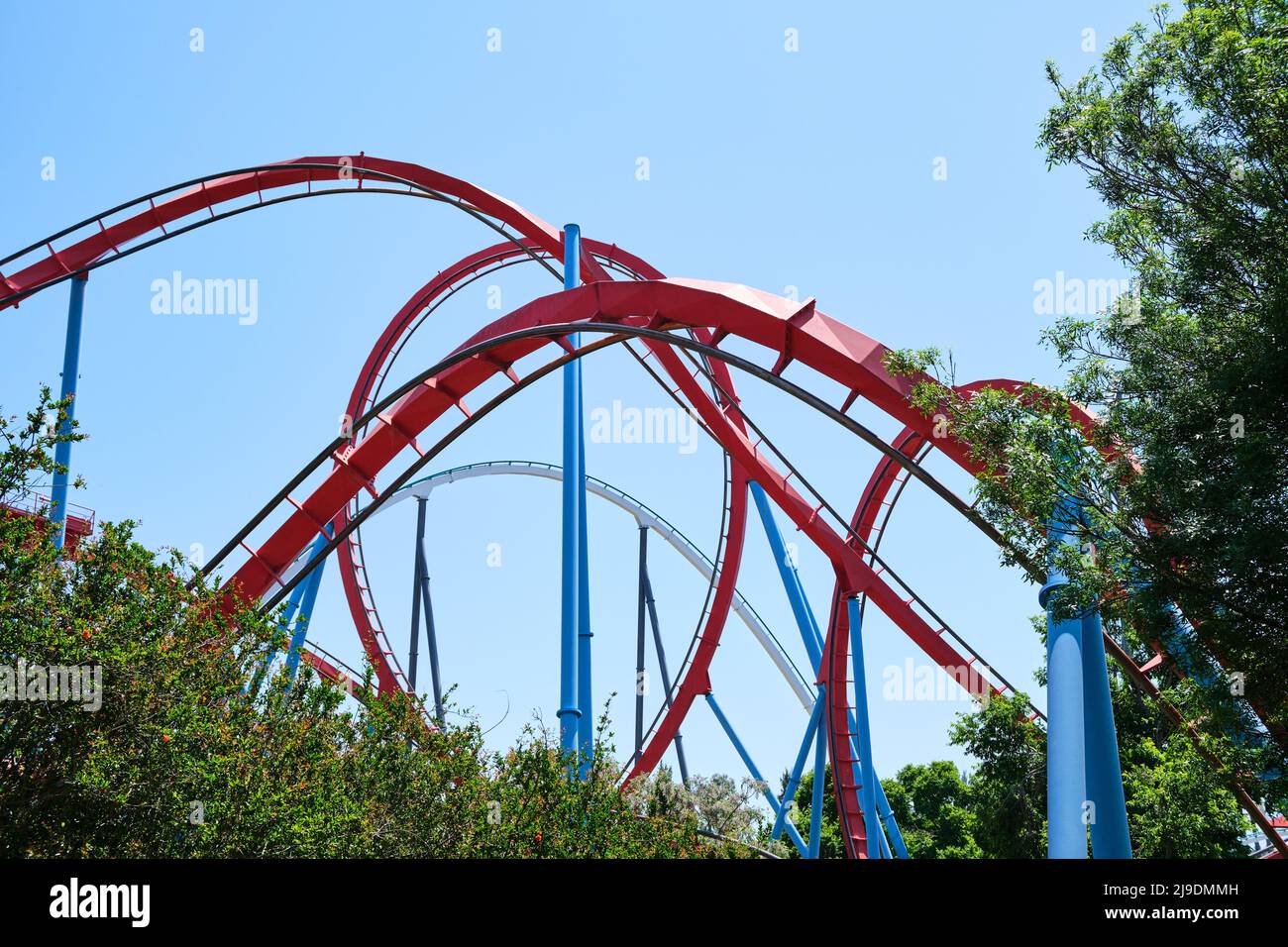 Inverted roller coaster with narrow metal rails, an ideal summer day to ...