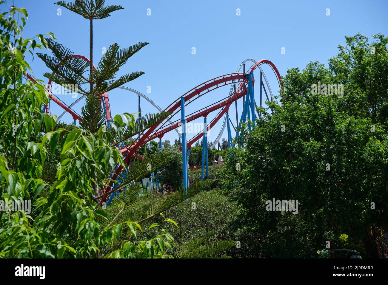 Inverted roller coaster with narrow metal rails, an ideal summer day to ...
