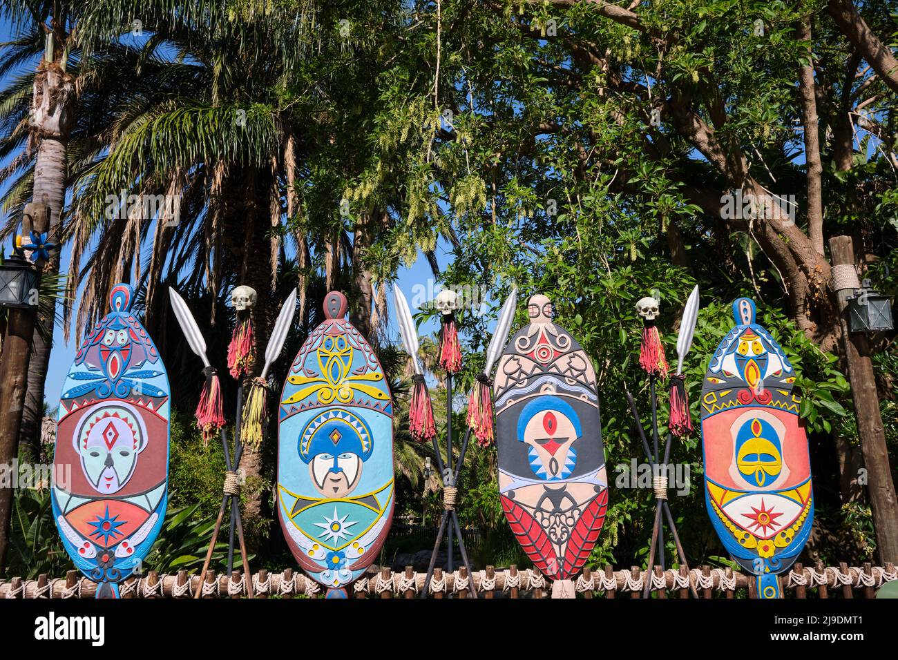 Traditional brightly colored Polynesian decorations on wooden boards ...