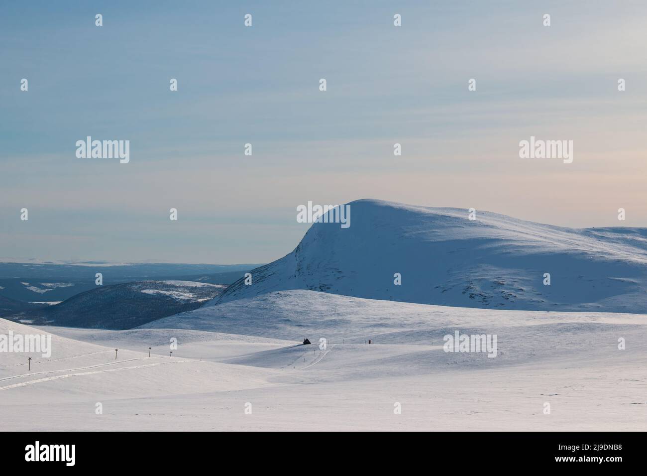 A winter ski and snowmobile trail downhill towards an emergency shelter ...