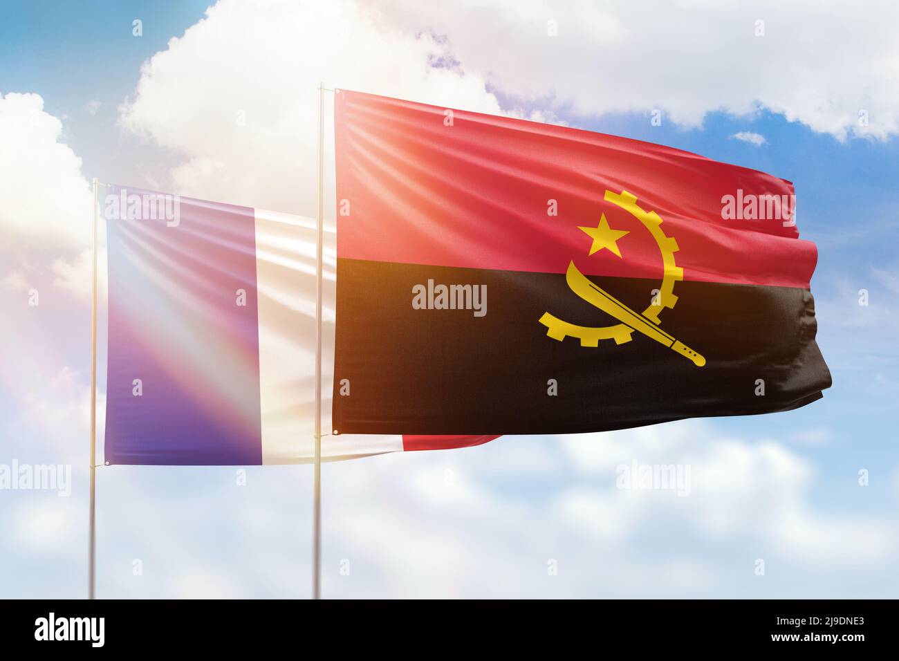 Sunny blue sky and flags of angola and france Stock Photo - Alamy
