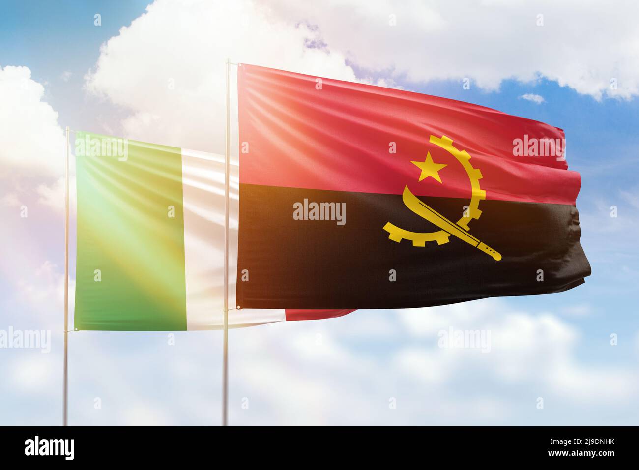 Sunny blue sky and flags of angola and italy Stock Photo - Alamy
