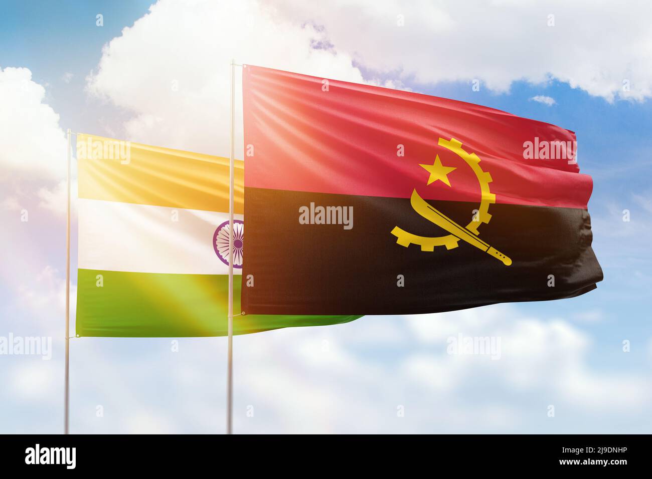 Sunny blue sky and flags of angola and india Stock Photo - Alamy