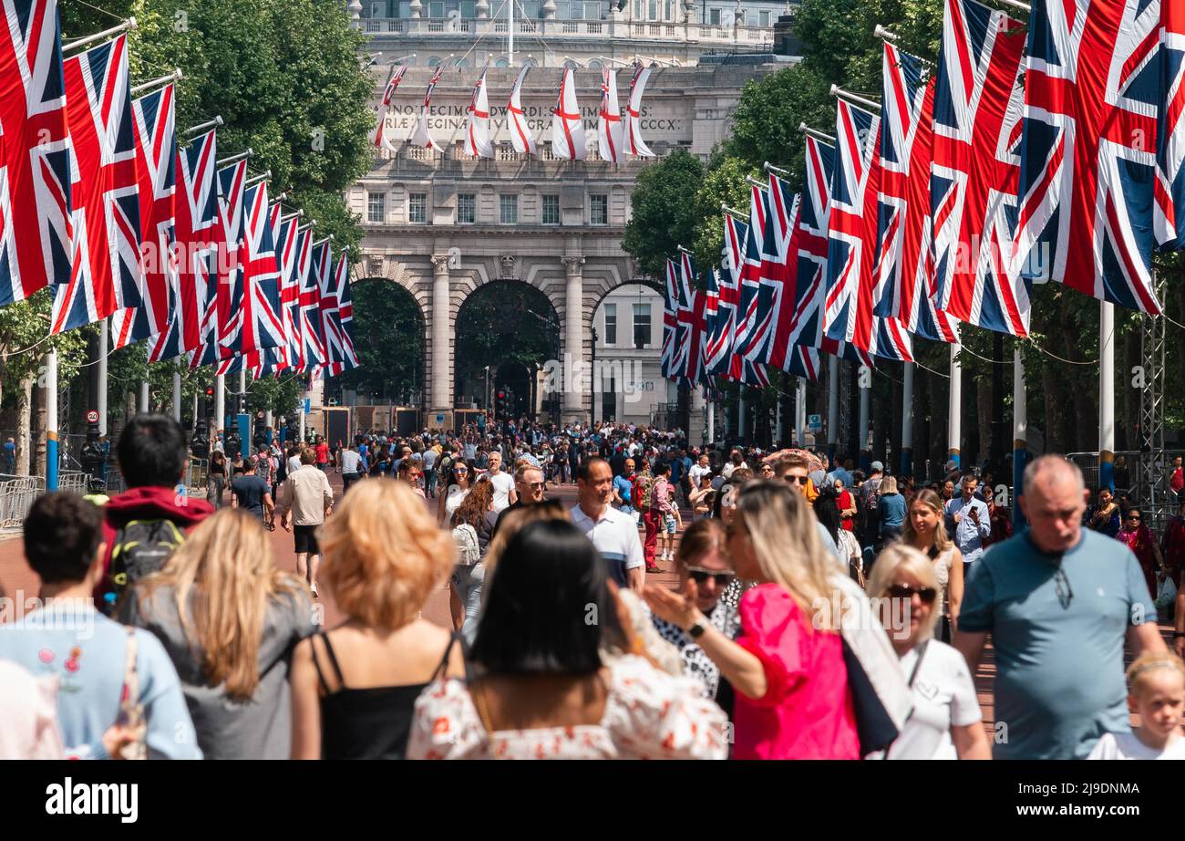Tourist takes photographs of the Union Jack flags hung from The Mall to ...