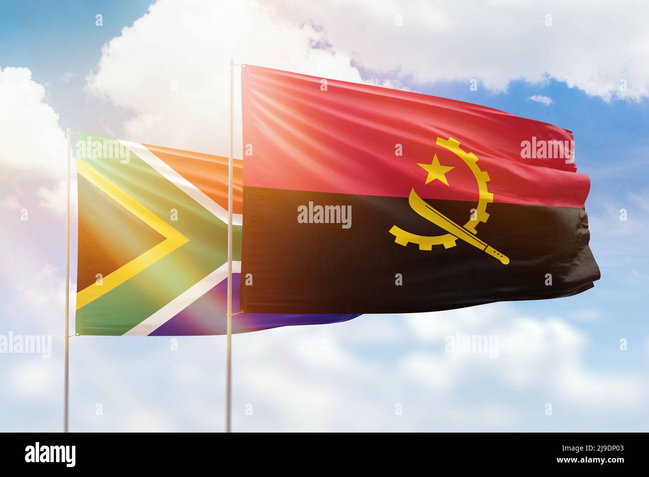 Sunny blue sky and flags of angola and south africa Stock Photo - Alamy