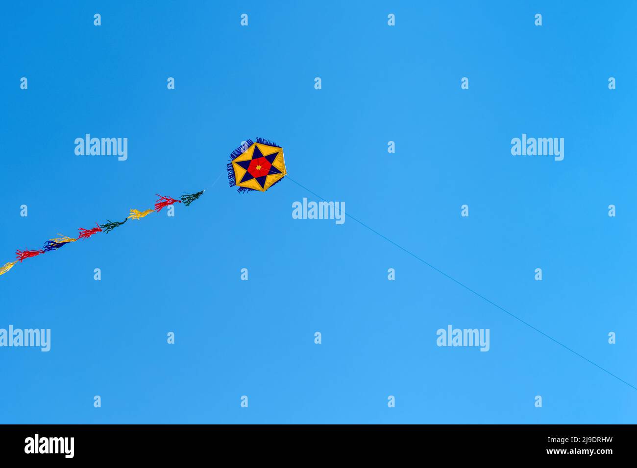 A colorful round kite soars high in the sky Blue sky. Sports kite ...