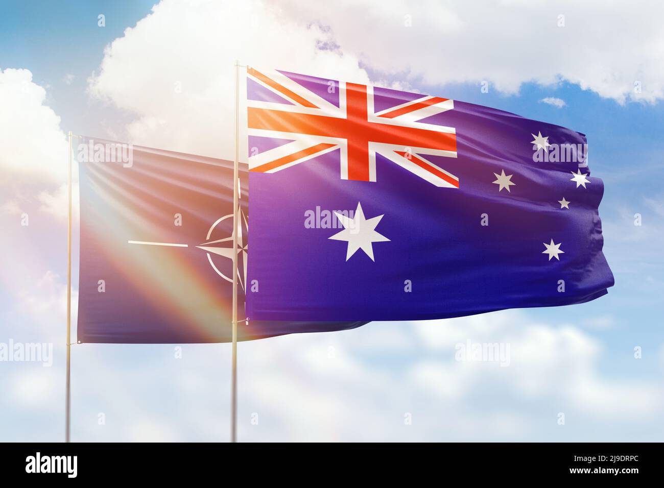 Sunny blue sky and flags of australia and nato Stock Photo - Alamy