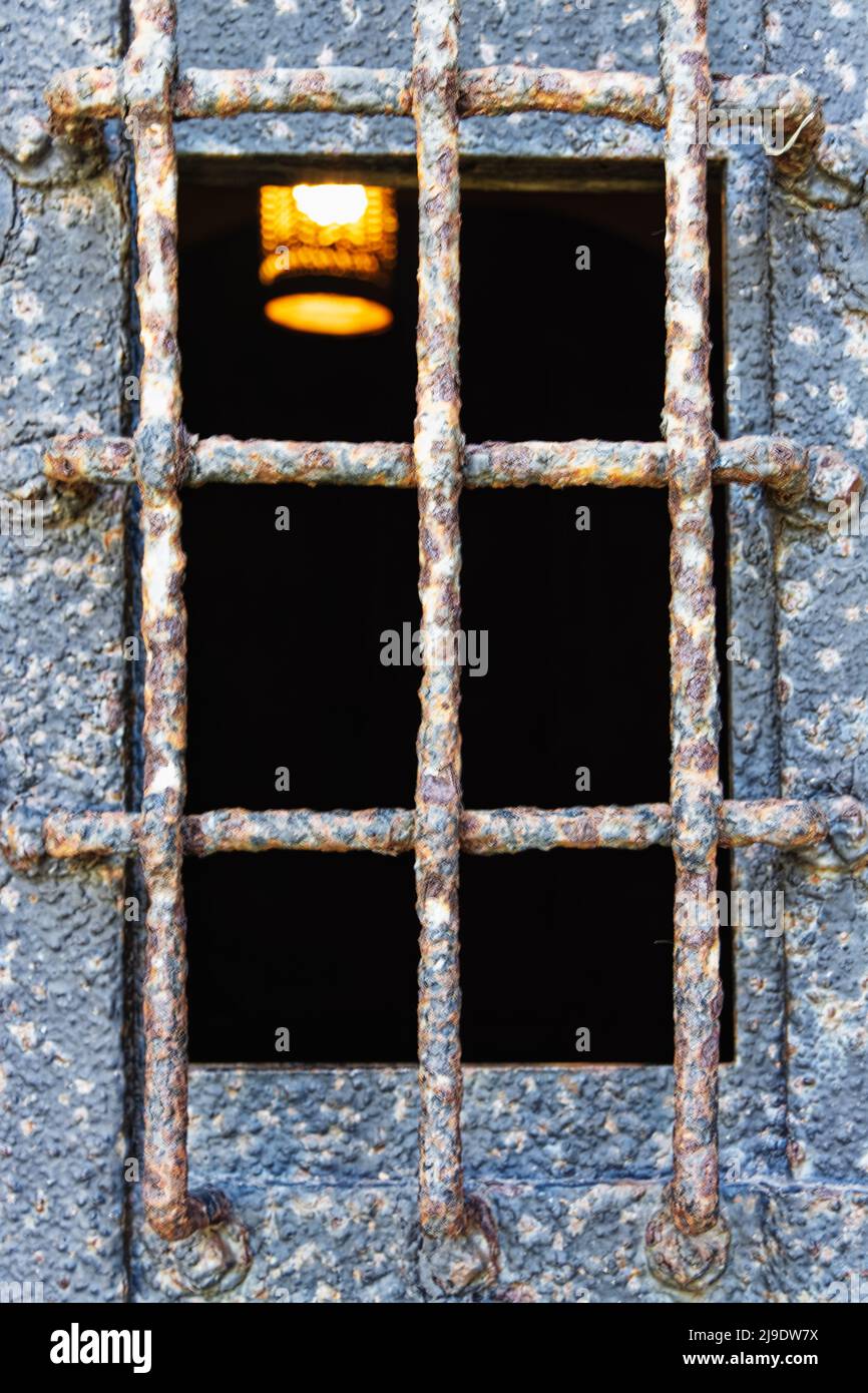 Window with metal bars across it on a fortified gray door to the 1926 ...