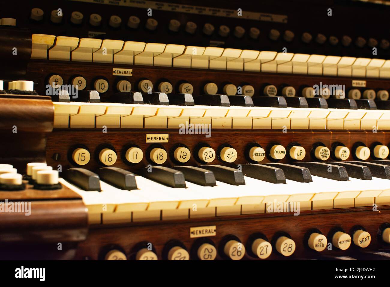 The keyboard of a vintage pipe organ with pictures and memorabilia at ...
