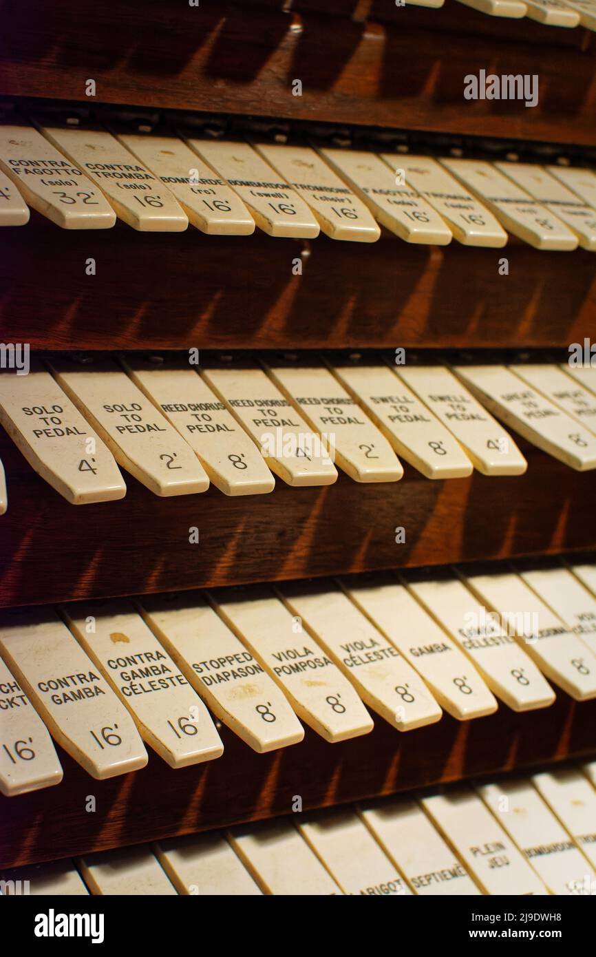 The keyboard of a vintage pipe organ with pictures and memorabilia at ...
