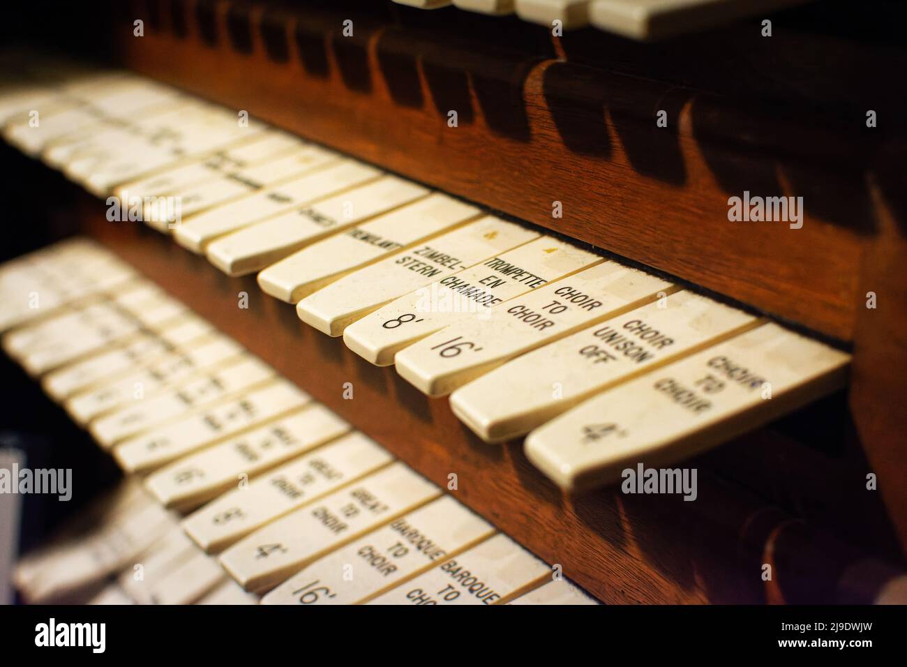 The keyboard of a vintage pipe organ with pictures and memorabilia at ...