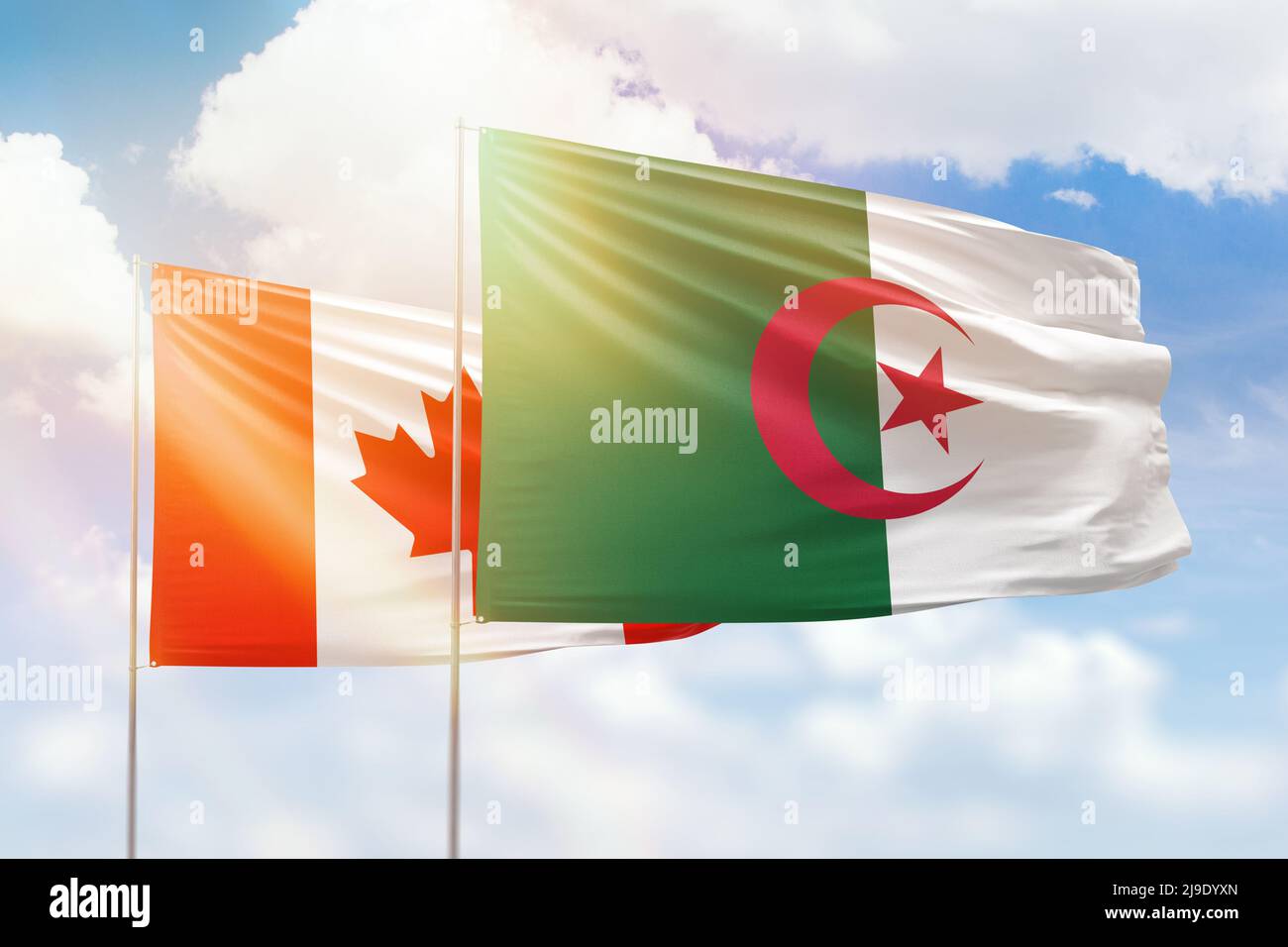 Sunny blue sky and flags of algeria and canada Stock Photo - Alamy
