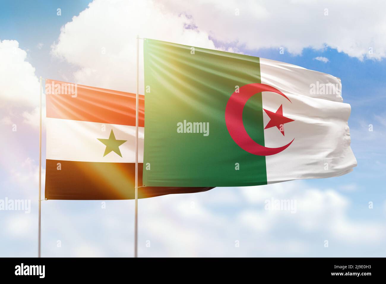 Sunny blue sky and flags of algeria and syria Stock Photo - Alamy