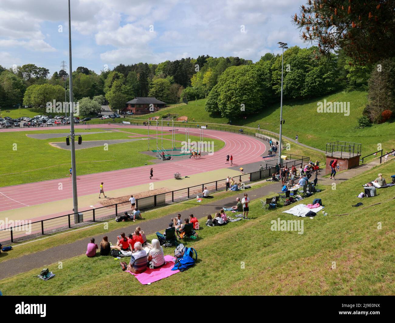 Spectators sitting on a sunny day watching athletics meeting at UK ...