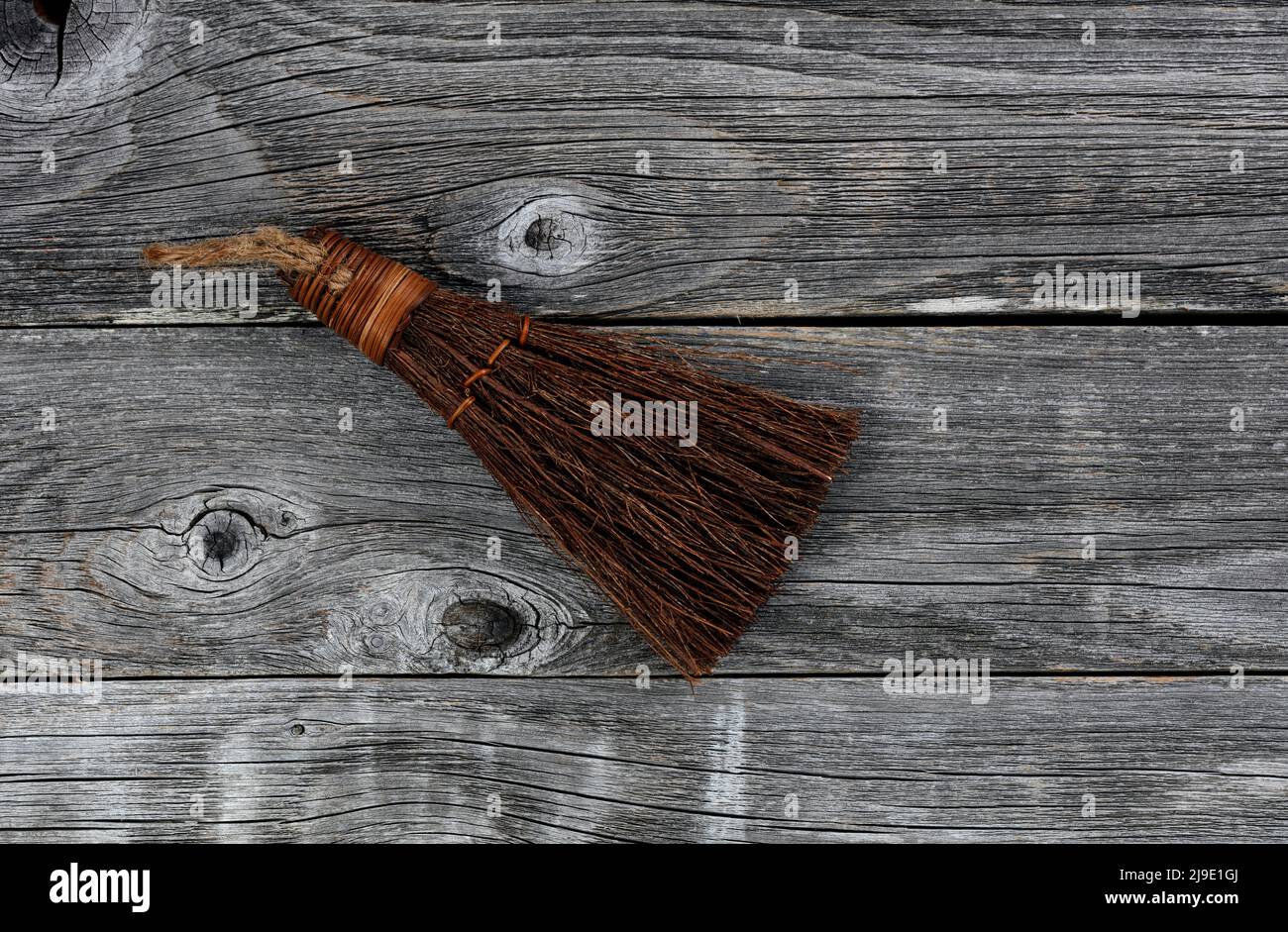 Vintage hand broom on aged wooden plank floor boards Stock Photo - Alamy