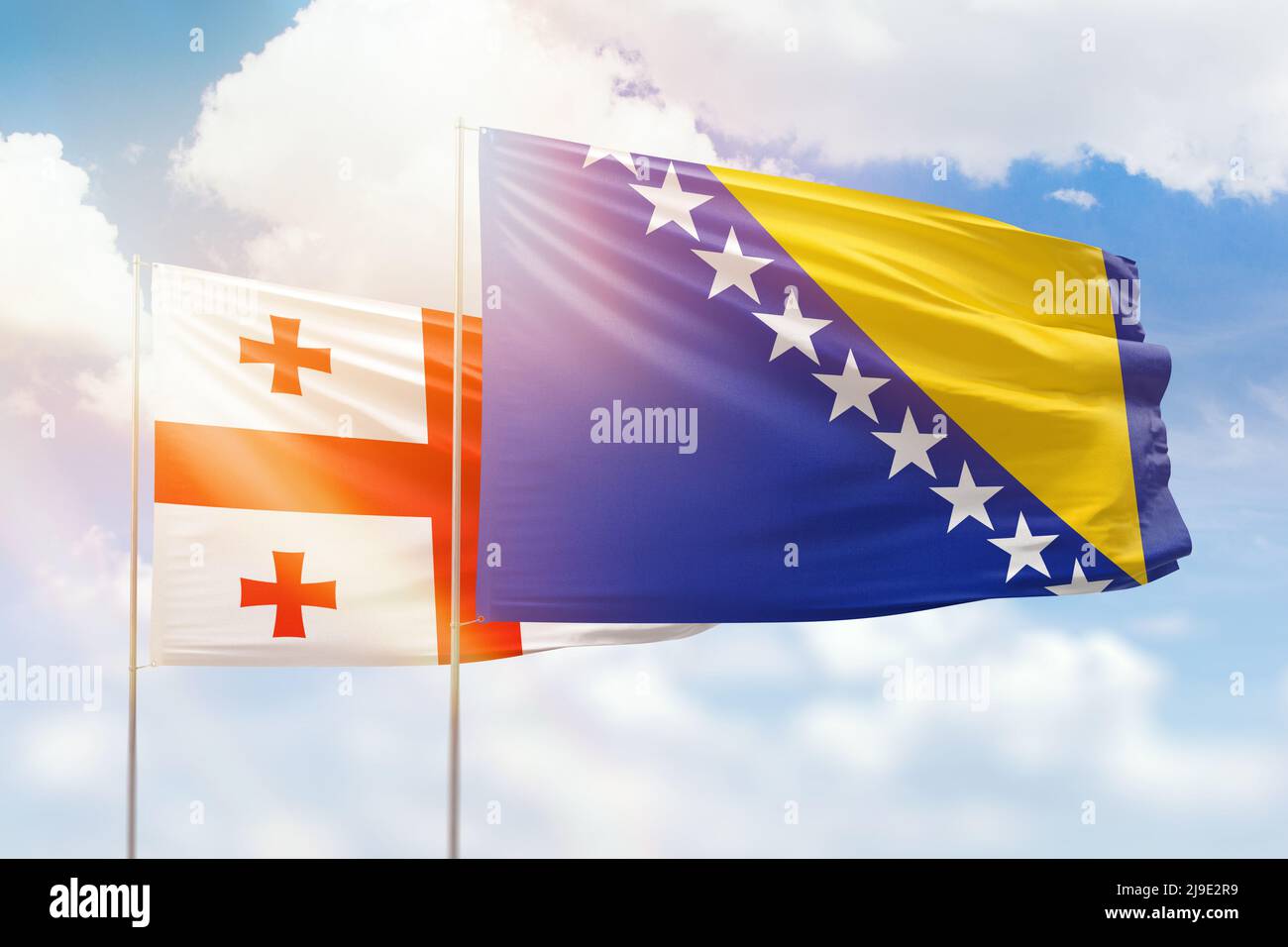 Sunny blue sky and flags of bosnia and georgia Stock Photo - Alamy