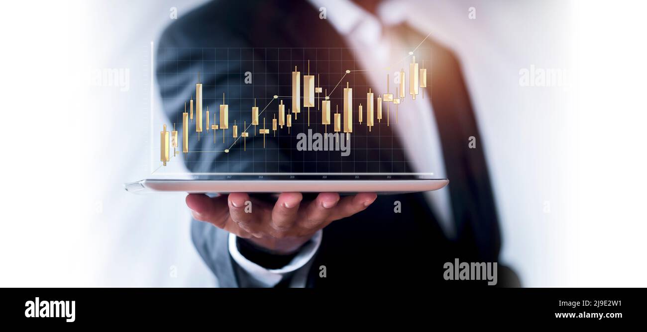 Hand of businessman holding tablet analysis stock market graph growth ...