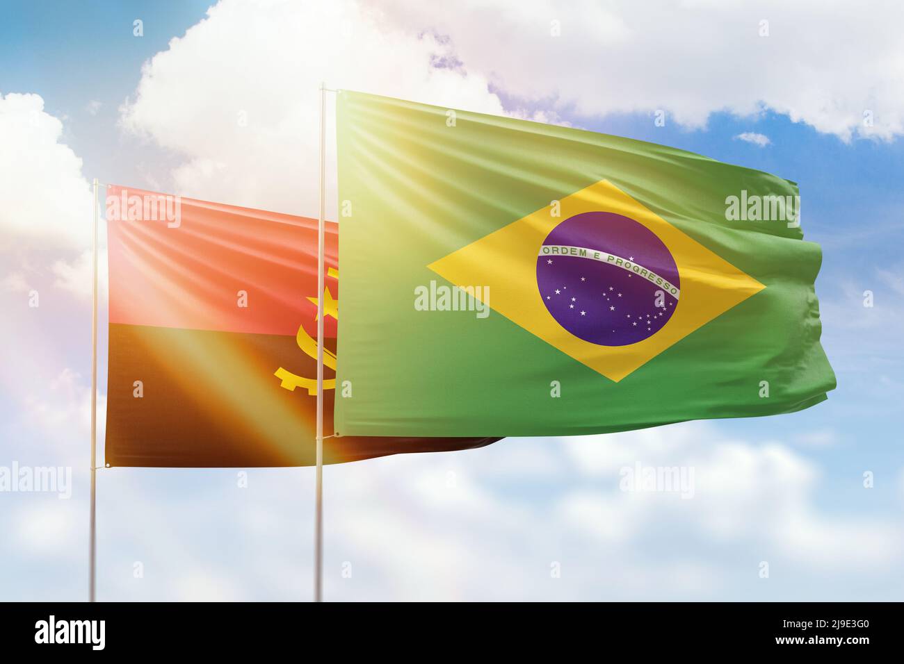 Sunny blue sky and flags of brazil and angola Stock Photo - Alamy