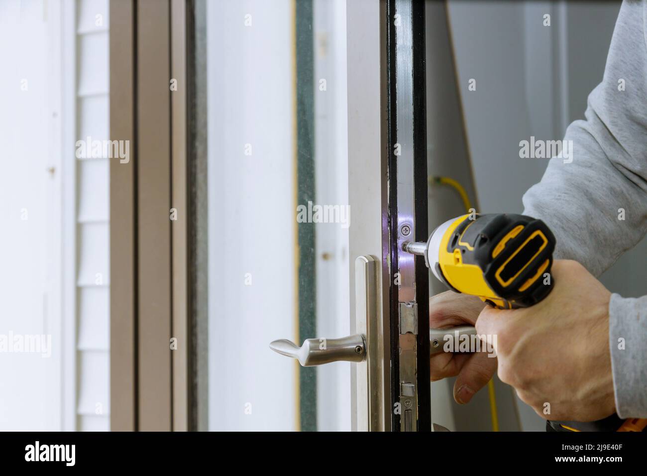 Locksmith install the door lock in house Stock Photo - Alamy