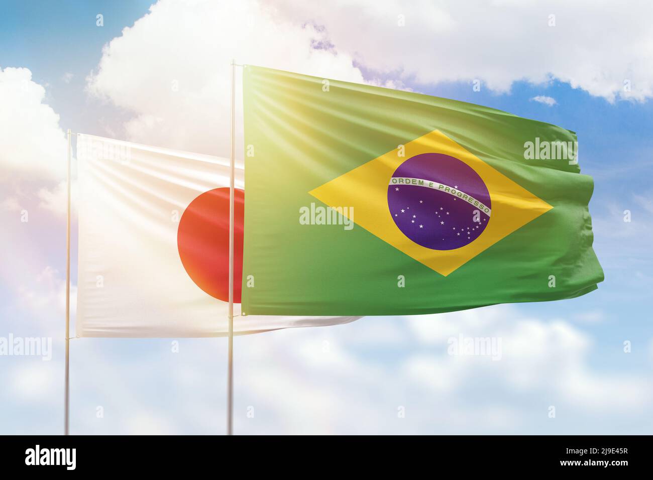 Sunny blue sky and flags of brazil and japan Stock Photo - Alamy