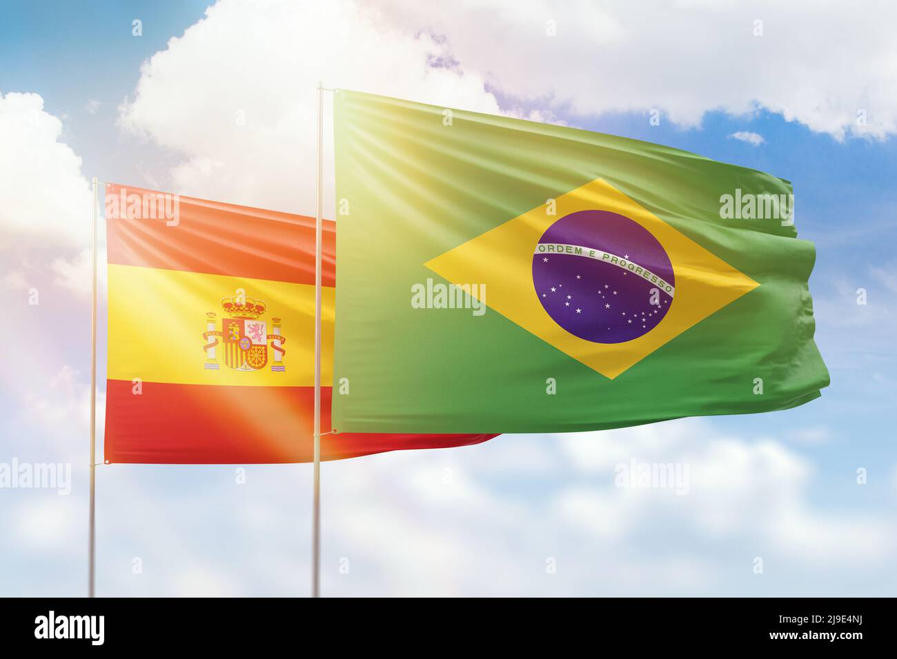 Sunny blue sky and flags of brazil and spain Stock Photo - Alamy