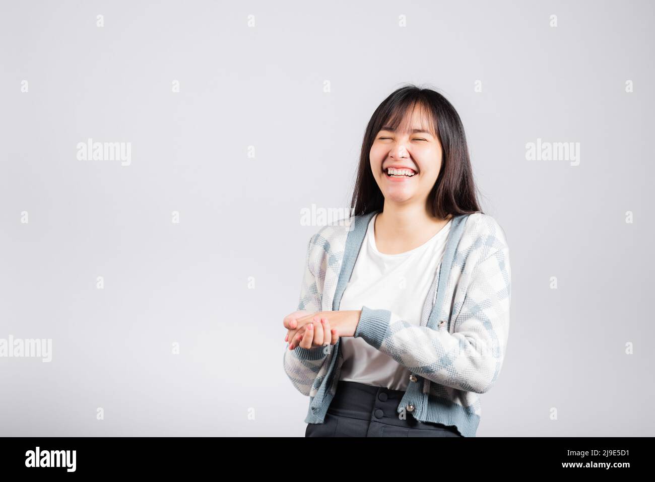 Woman winning and surprised excited screaming laughing studio shot ...