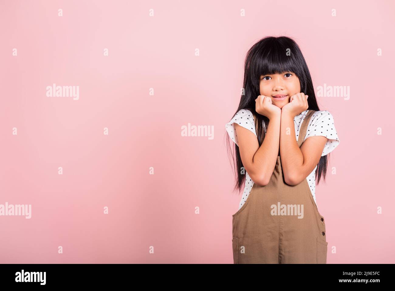 Asian little kid 10 years old hands touch chin thinking dream at studio ...