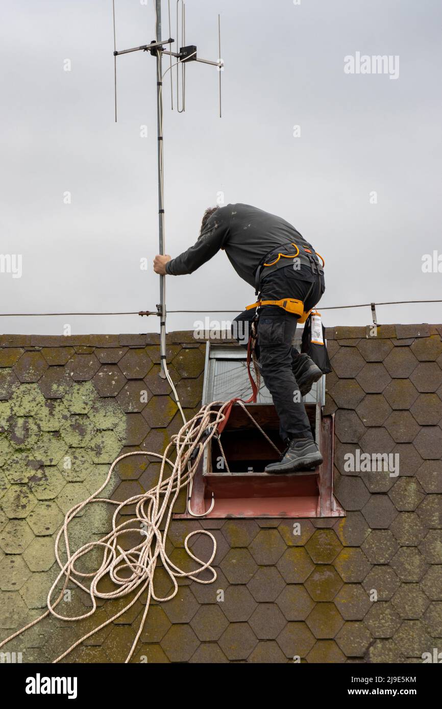 A man works on a roof with a skylight Stock Photo - Alamy