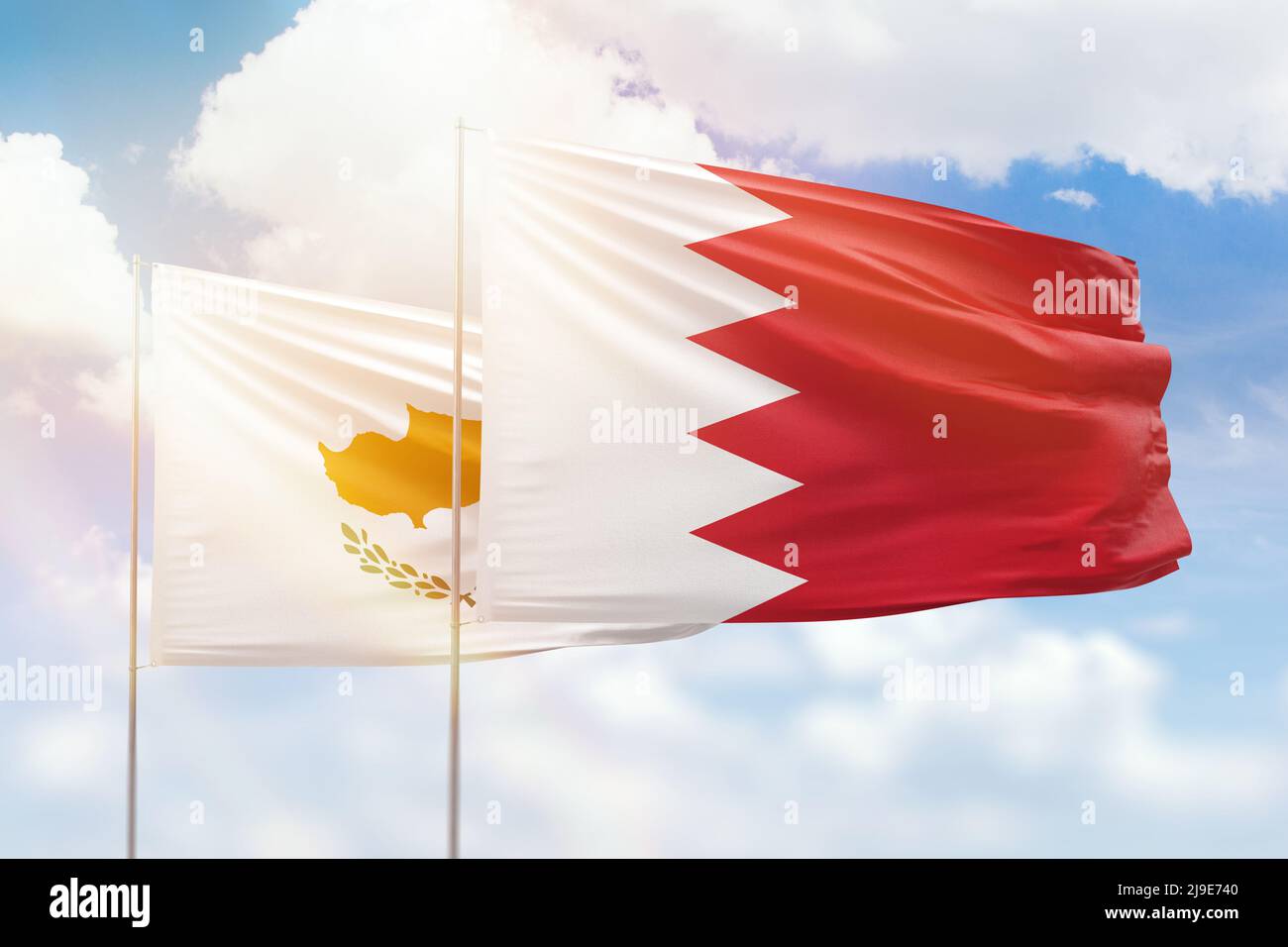 Sunny blue sky and flags of bahrain and cyprus Stock Photo - Alamy