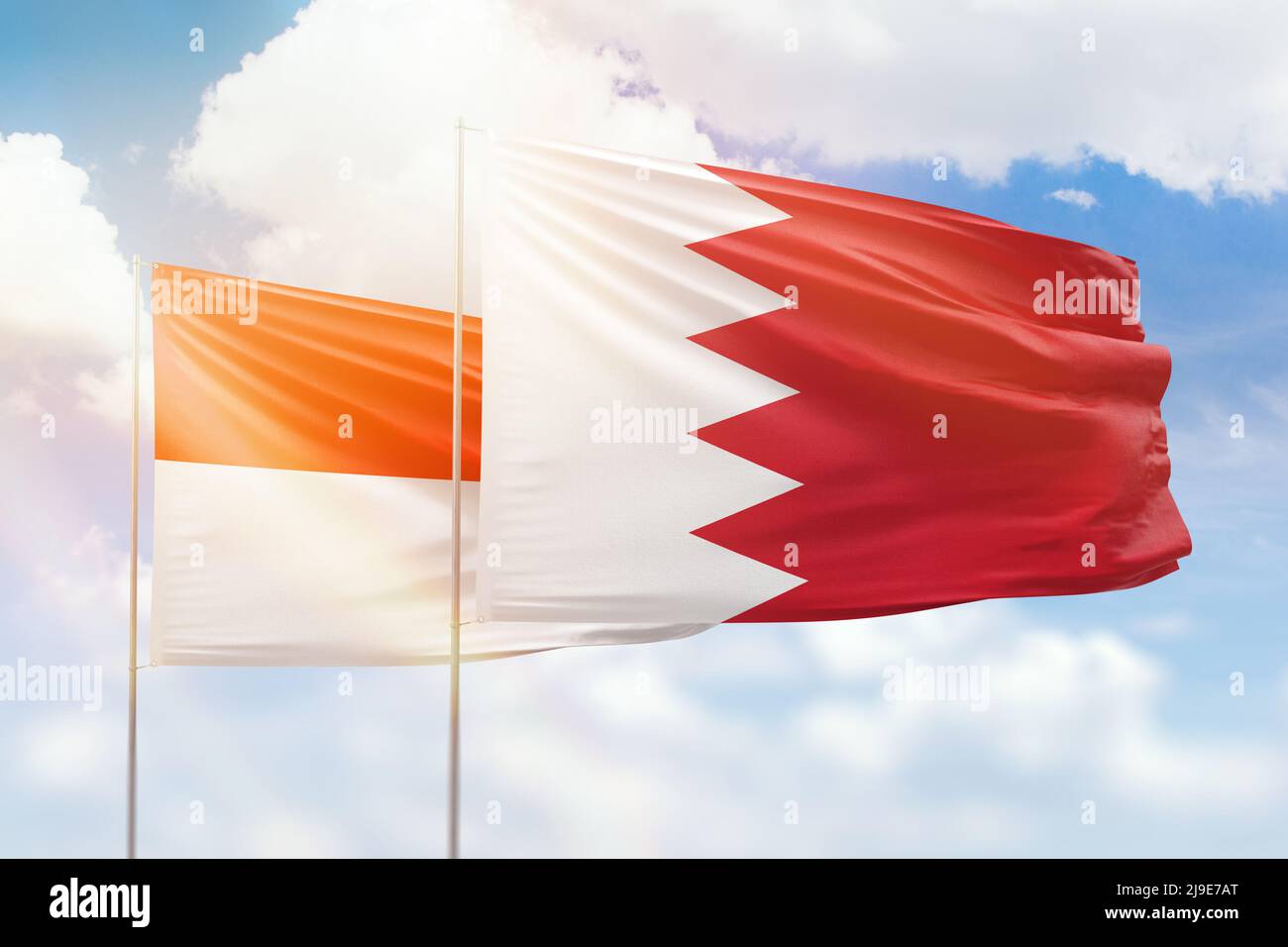 Sunny blue sky and flags of bahrain and indonesia Stock Photo - Alamy