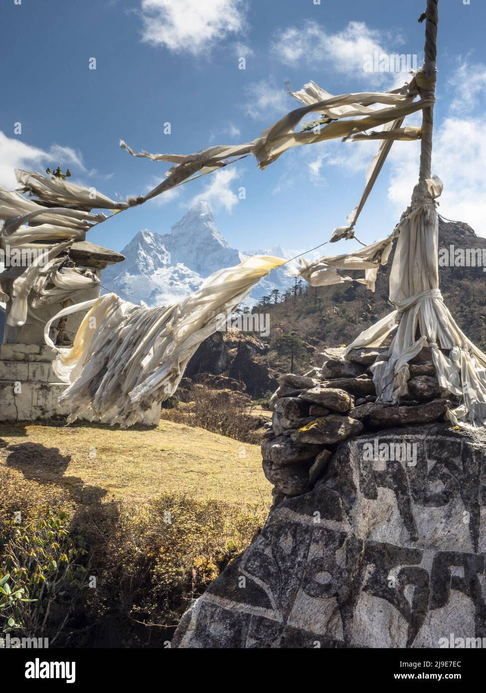 Ama Dablam (6856m) framed by prayer flags at a small pass above Khunde ...