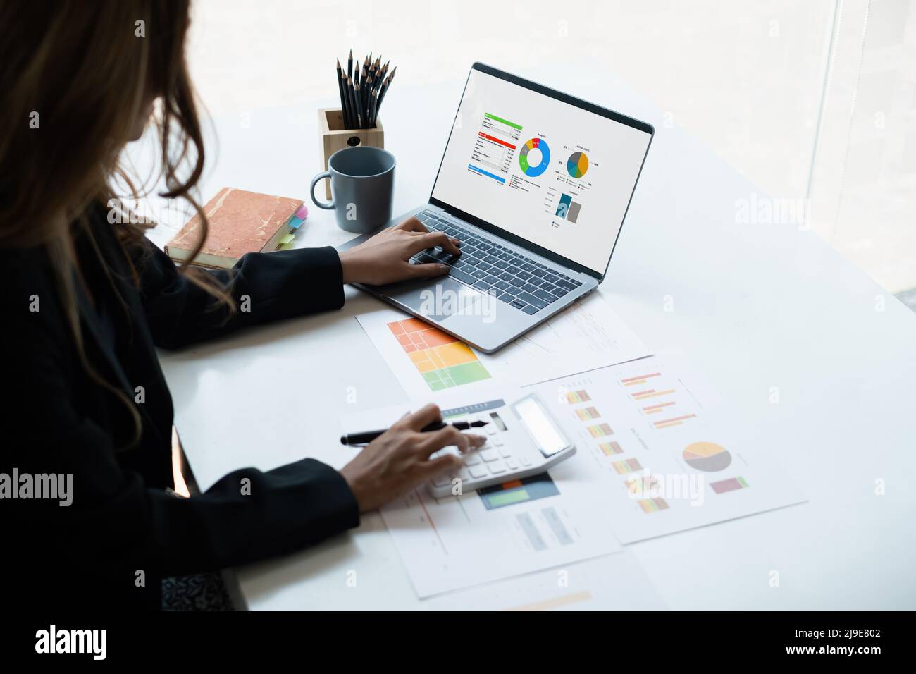 Close up Business woman hand using laptop and calculator to calculate ...