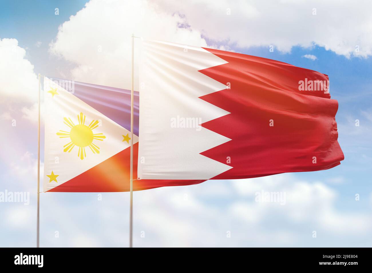 Sunny blue sky and flags of bahrain and philippines Stock Photo - Alamy