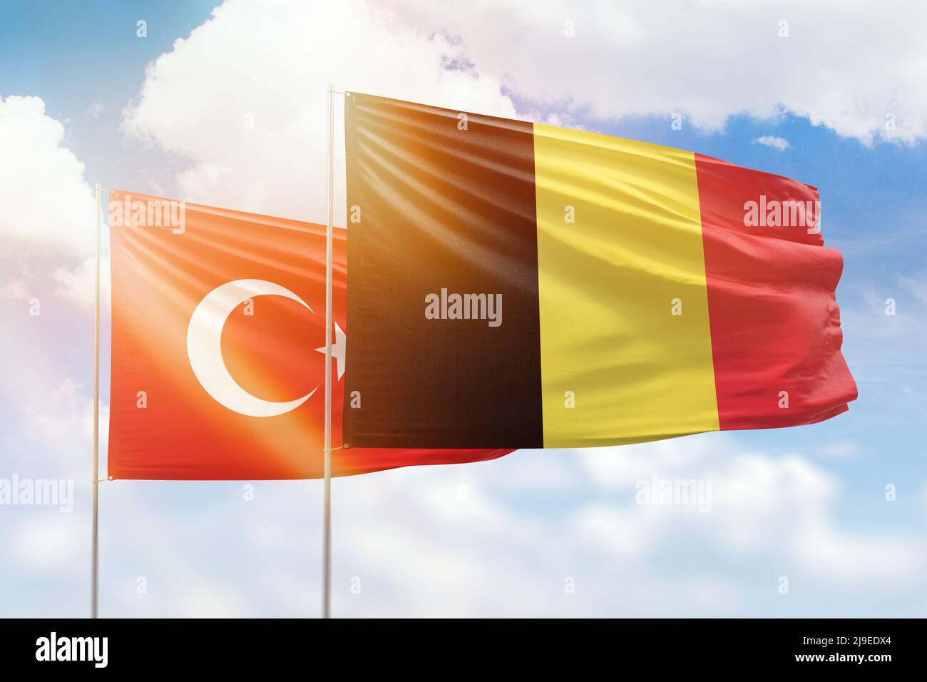 Sunny blue sky and flags of belgium and turkey Stock Photo - Alamy