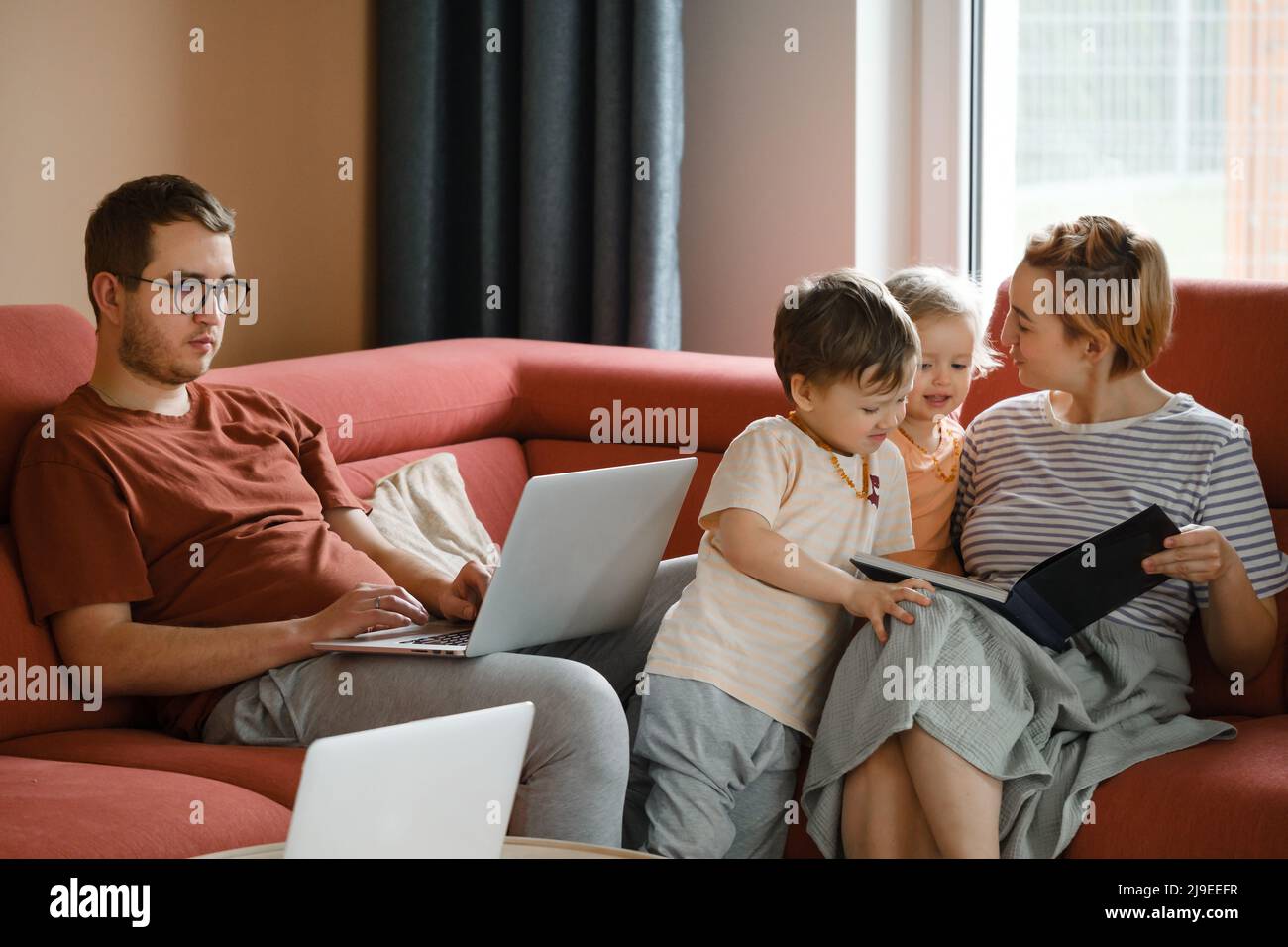 Big happy family watching movies playing games on laptop. Mother father ...