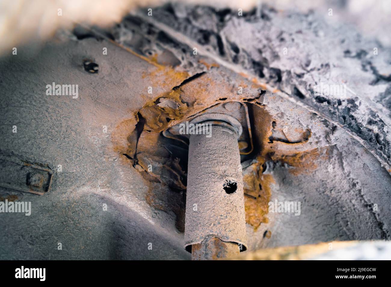 A rotten car shock absorber mount. Corrosion of the car body after ...