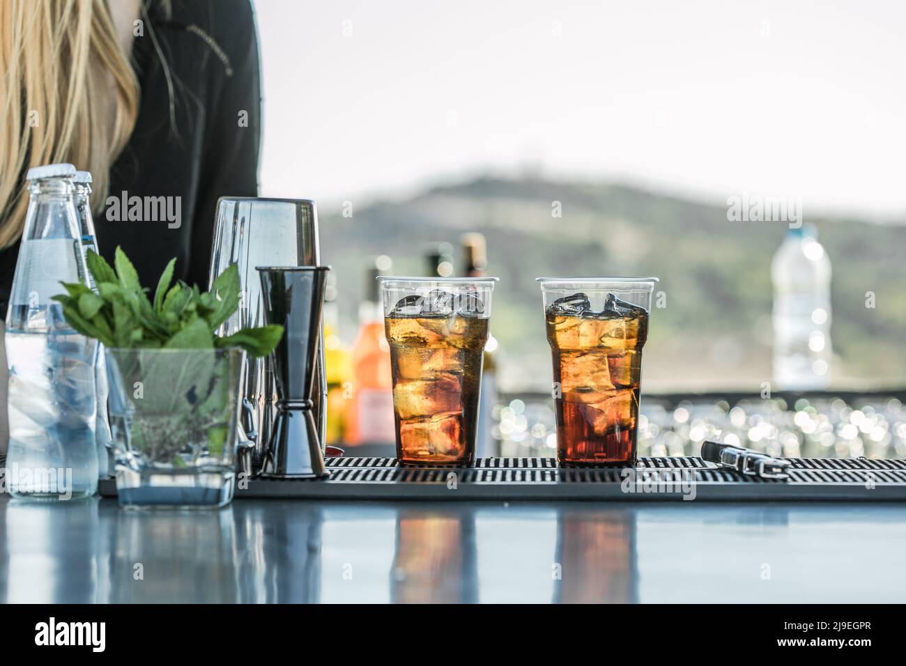 Expert barwoman is making cocktail at night club or bar. Alcoholic, non ...