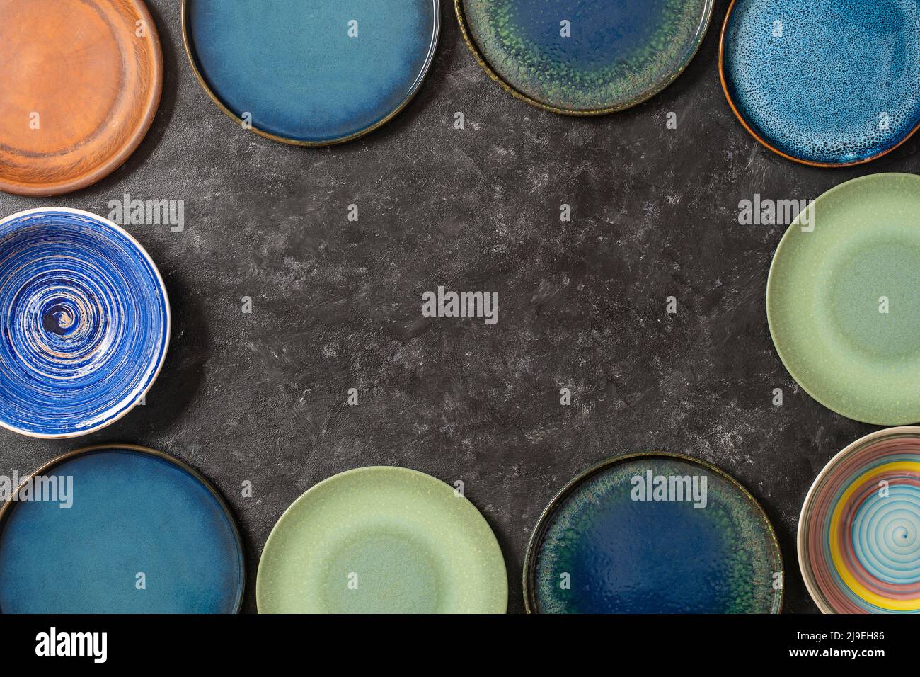 Many color empty ceramic plate on black background, with copy space for ...
