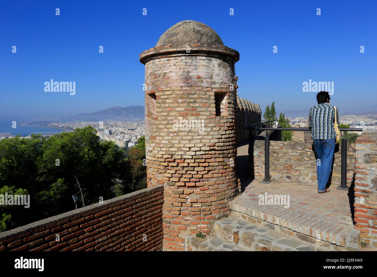 Tourist stands by the tower Stock Photo - Alamy