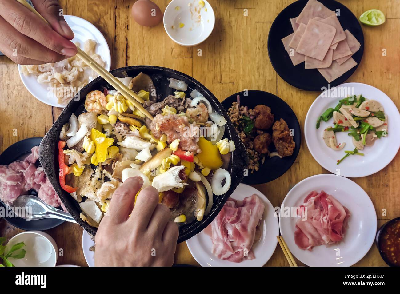 BBQ Barbecue eating. People grilling pork, meal, shellfish and shrimp ...
