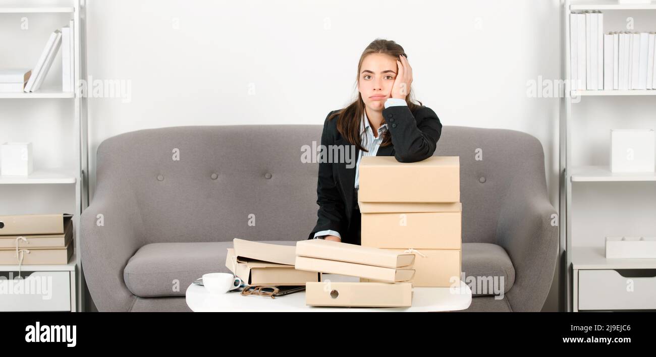 Sad busy secretary with folders with the documents, stressed overworked ...