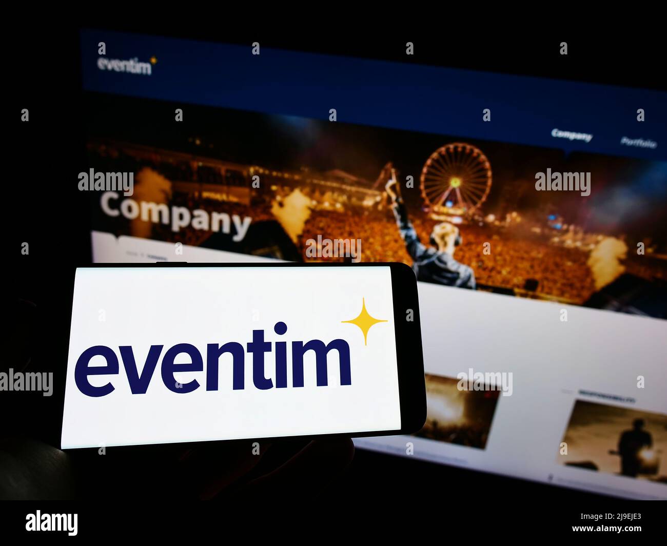 Person holding mobile phone with logo of German ticketing company CTS ...