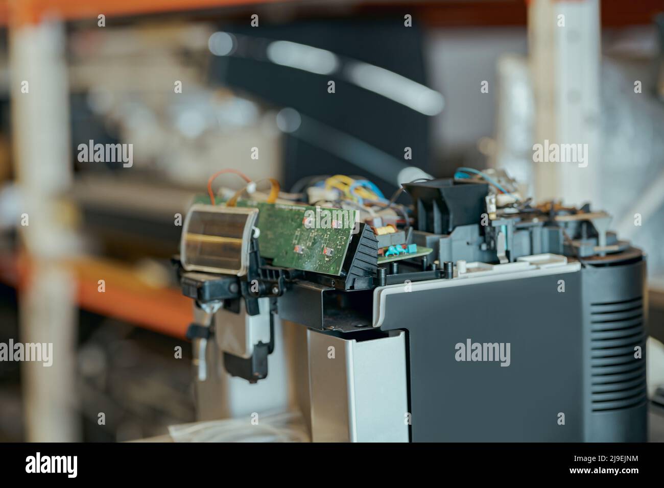 A disassembled coffee machine stands in a warehouse ready for repair ...