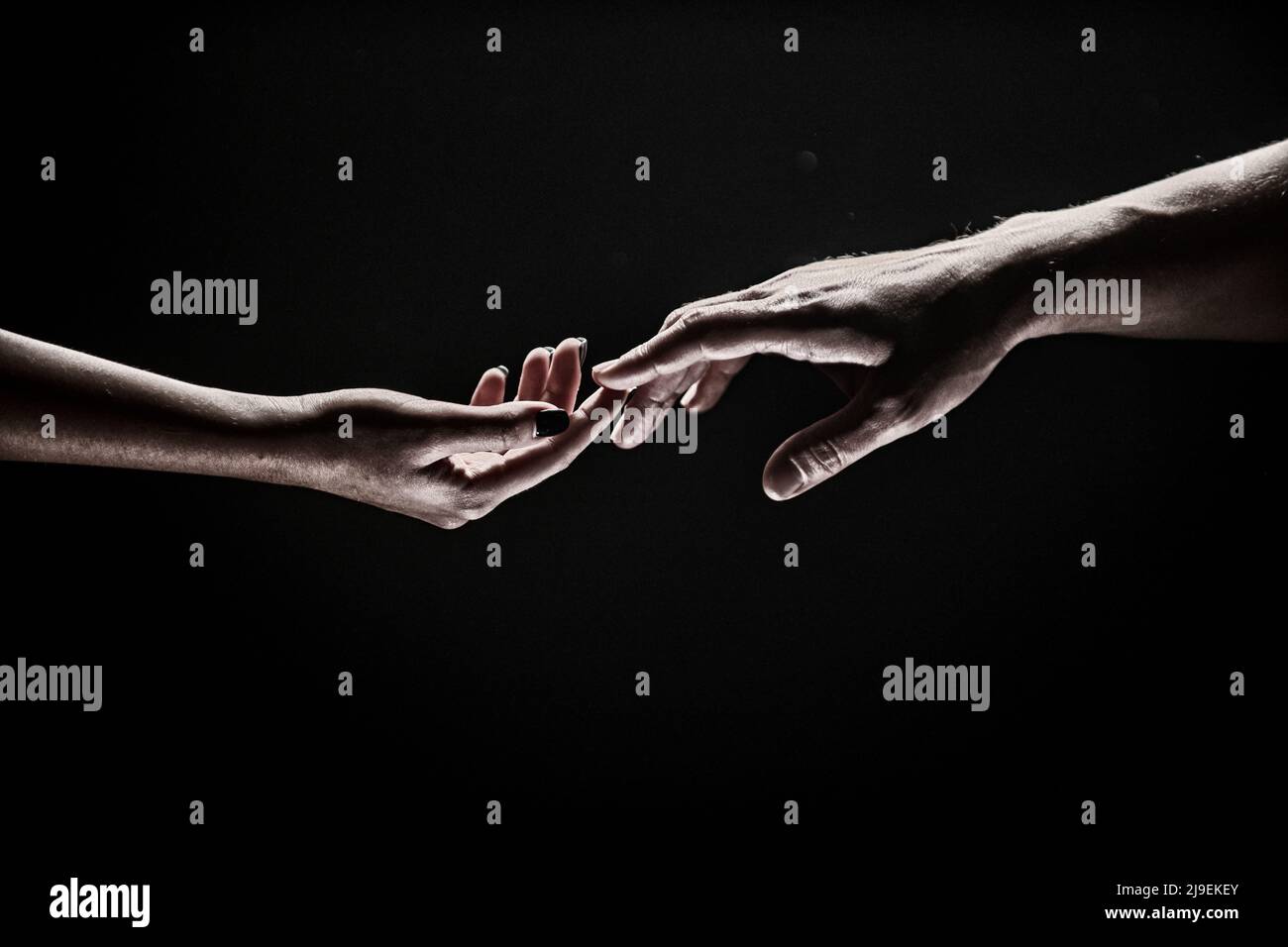 Romantic touch with fingers, love. Two hands stretch each other, black ...