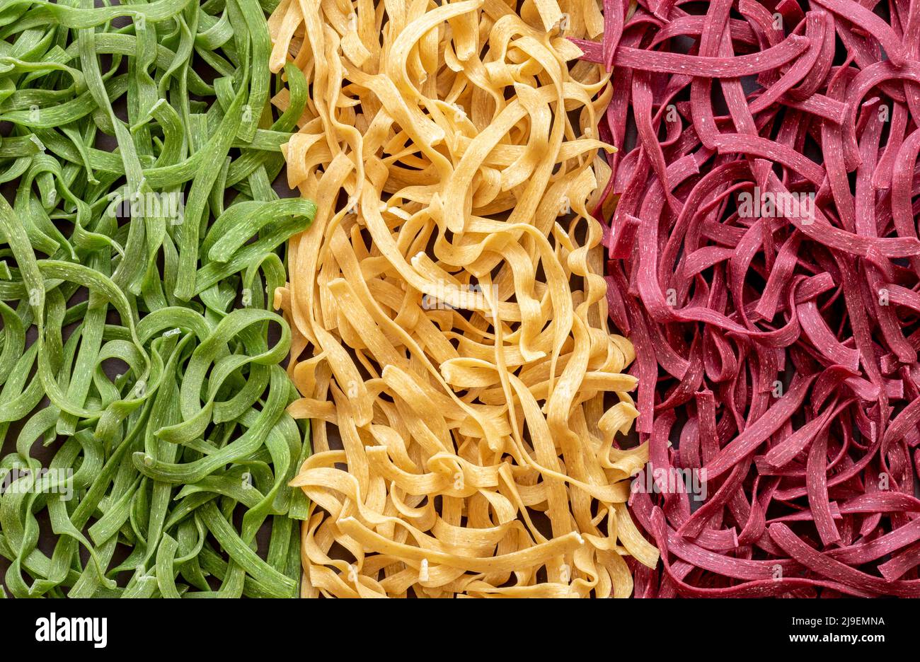 Above view with tricolor pasta arranged as the Italian flag. Uncooked ...