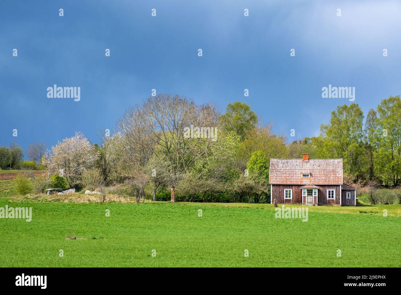 Old farmhouse at a field with rain clouds Stock Photo - Alamy