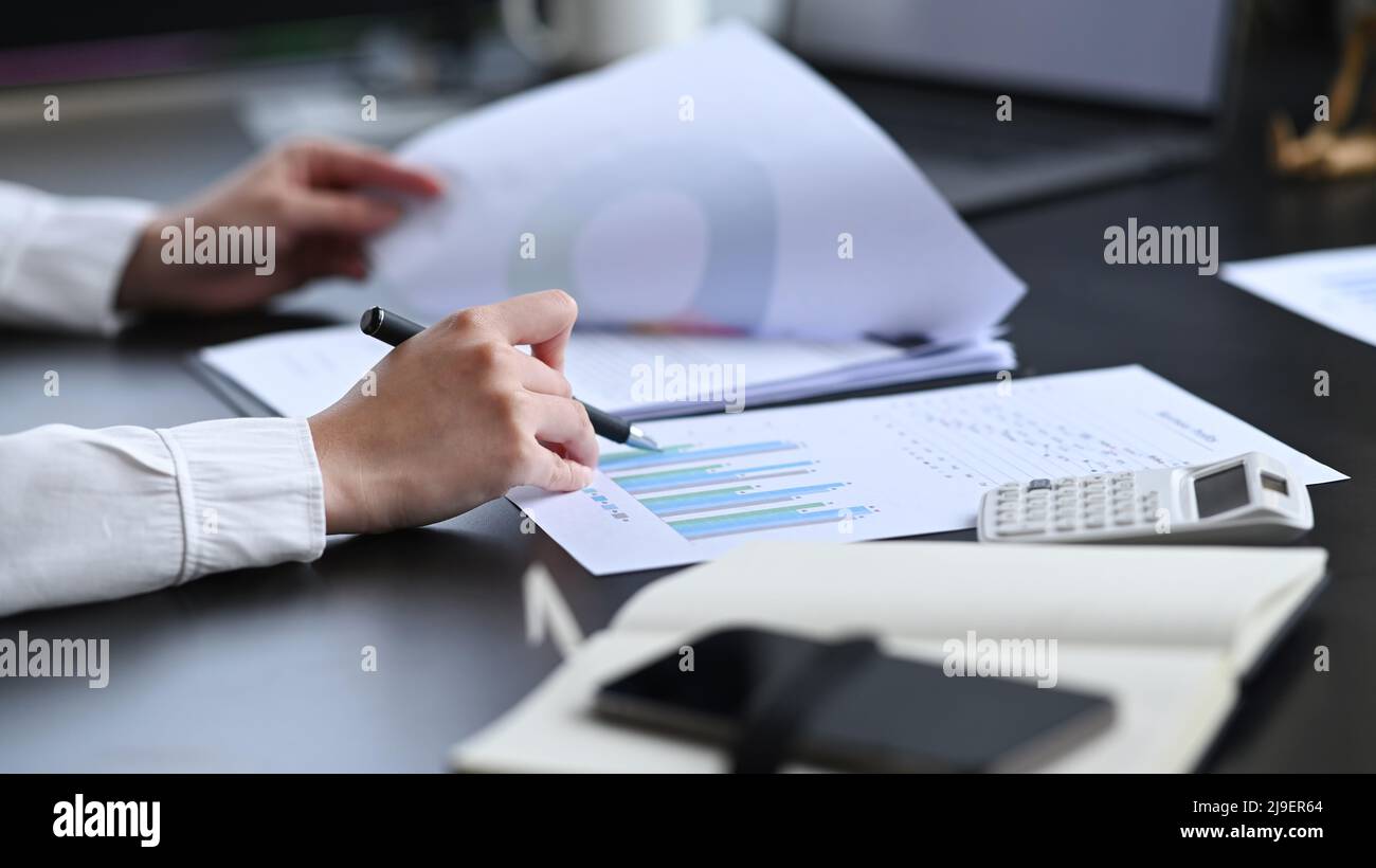 Cropped shot professional chartered accountant checking financial ...